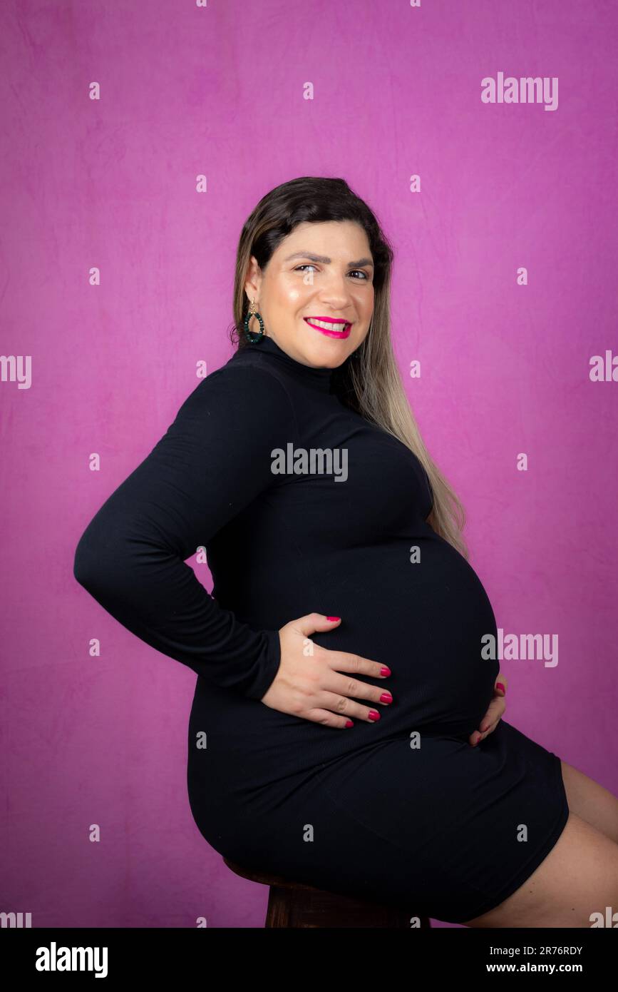 A Beautiful Pregnant Woman Wearing A Black Outfit In A Graceful Pose