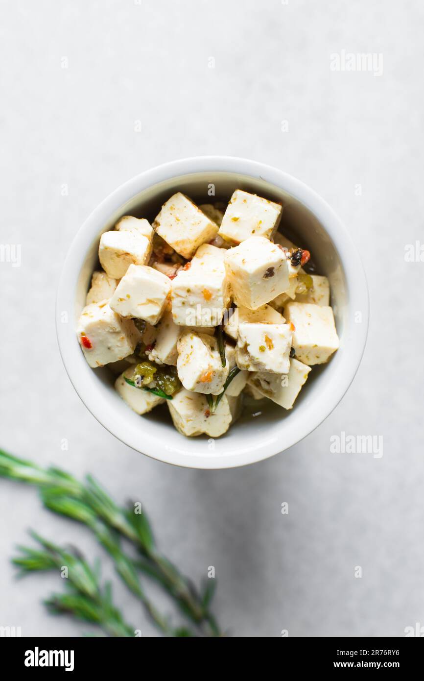 Top view of marinated feta cheese cubes in a ramekin, Cheese cubes ...