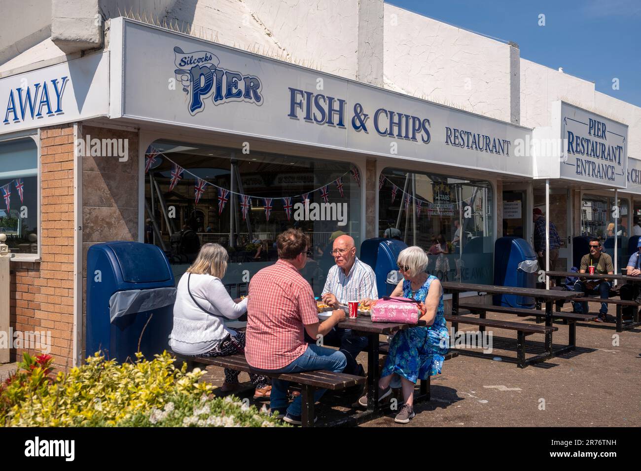Southport, Merseyside, on a warm and sunny day. People eating fish ...