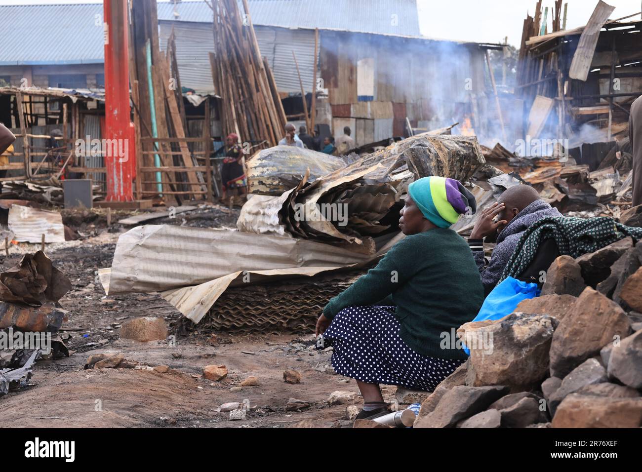 Nairobi, Kenya. 11th June, 2023. Traders sit next to their burnt down ...