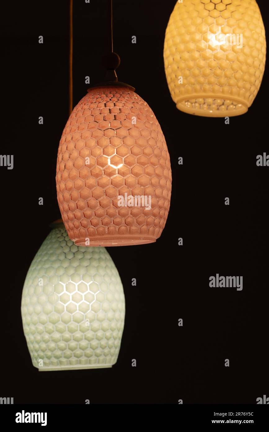 Modern chandelier with colorful glass lamp shades in the dark, close up ...