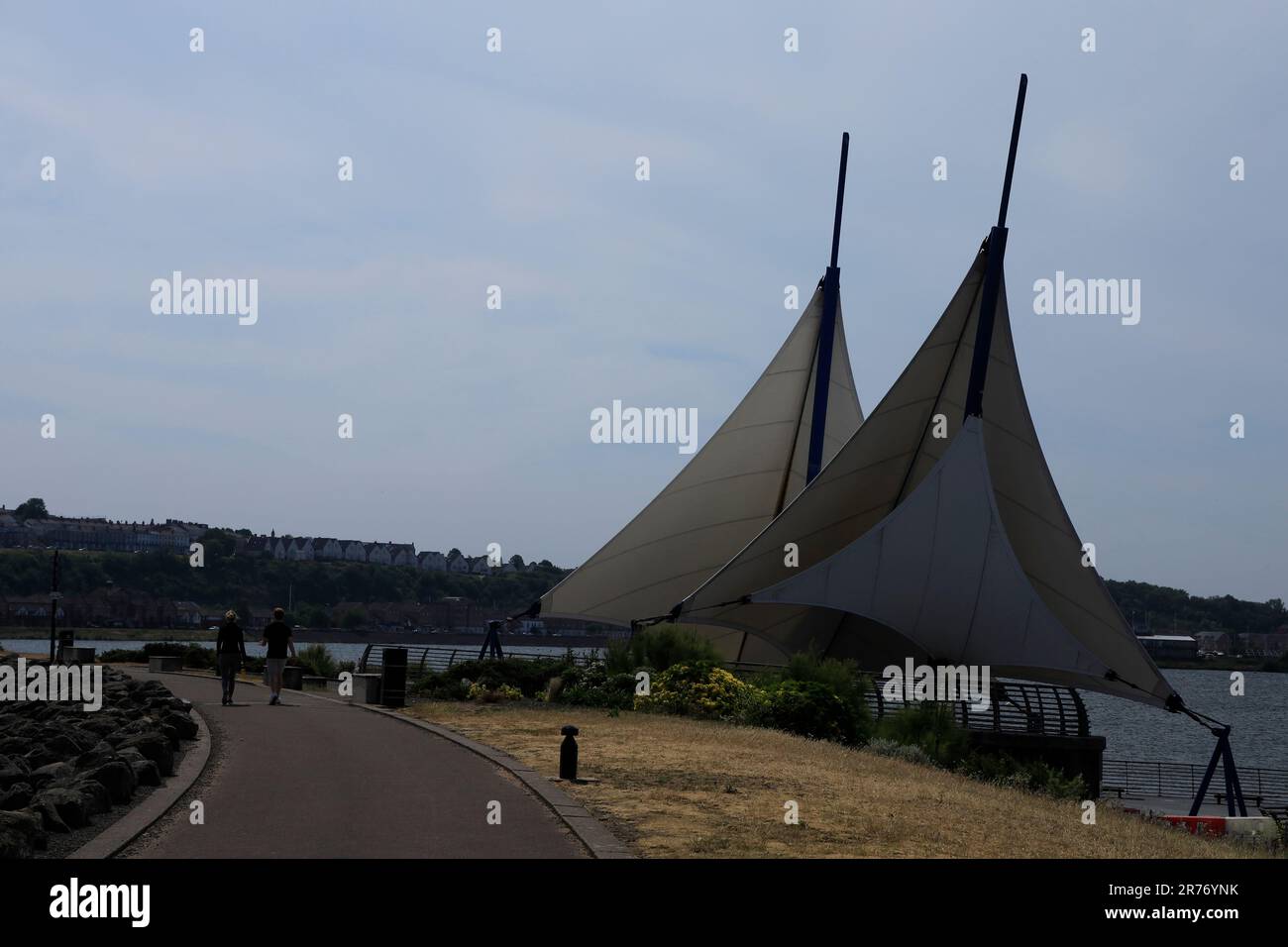 Young couple walking along Cardiff Bay Barrage, . June 2023. Summer ...