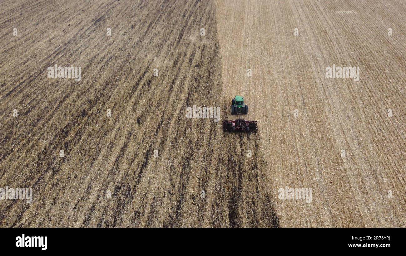 Drone flying after green tractor hi-res stock photography and images ...