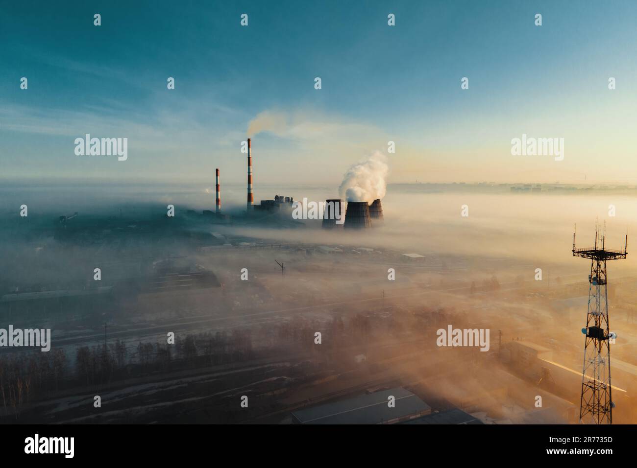 View of the horizon in the morning mist and smoke. Smoke comes out of ...