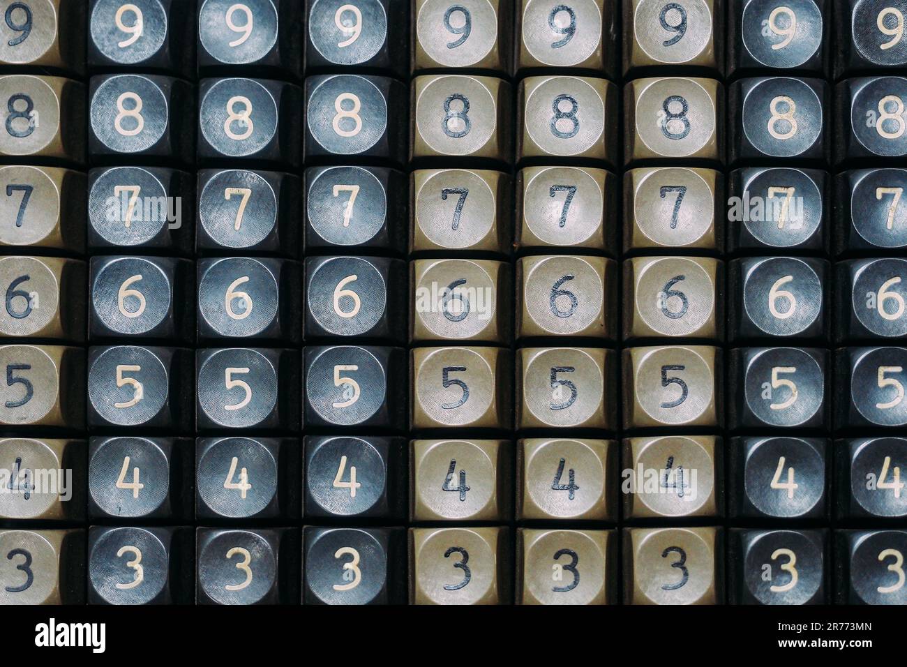A solid background of numbers on the plastic buttons of an outdated ...