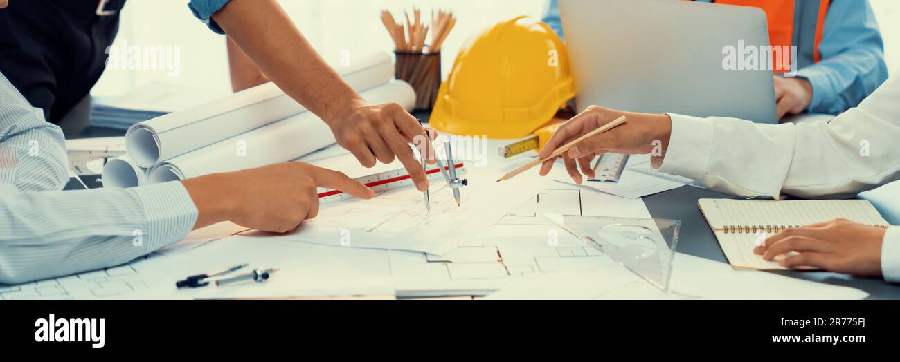Architect or engineer working on building blueprint, contractor ...