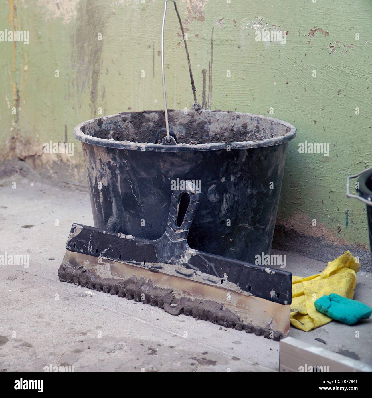 A spatula and a bucket against the wall. Plasterer's tool Stock Photo ...