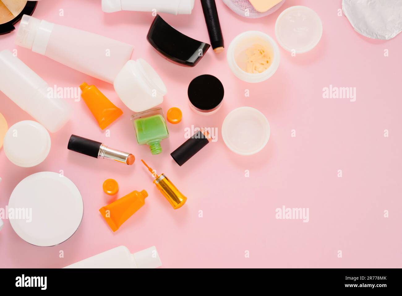 Used plastic packaging for cosmetics on a pink background. Manage waste ...