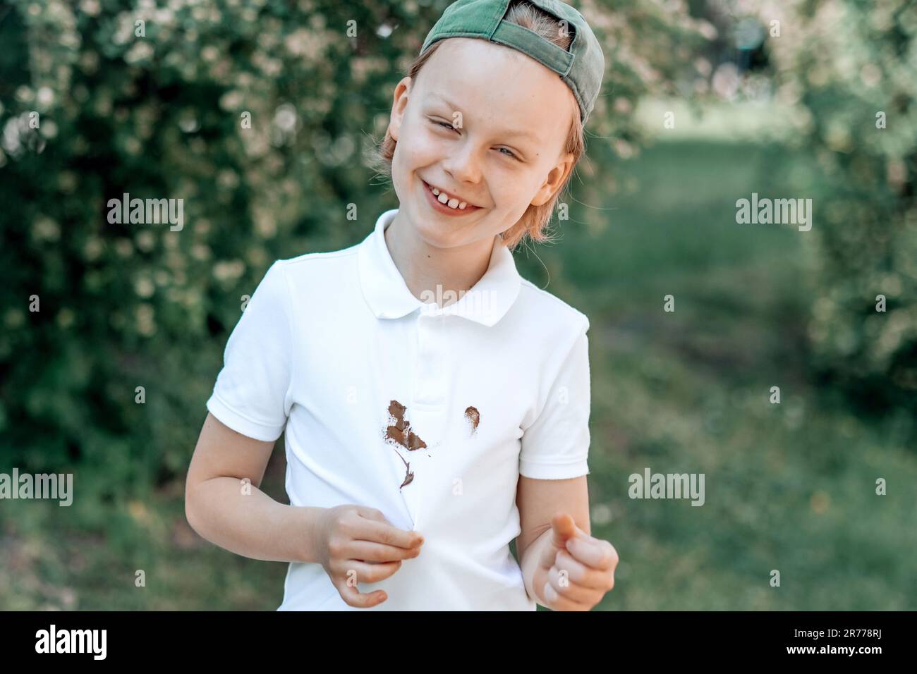 Portrait smiling face a child with dirty chocolate stains on white ...