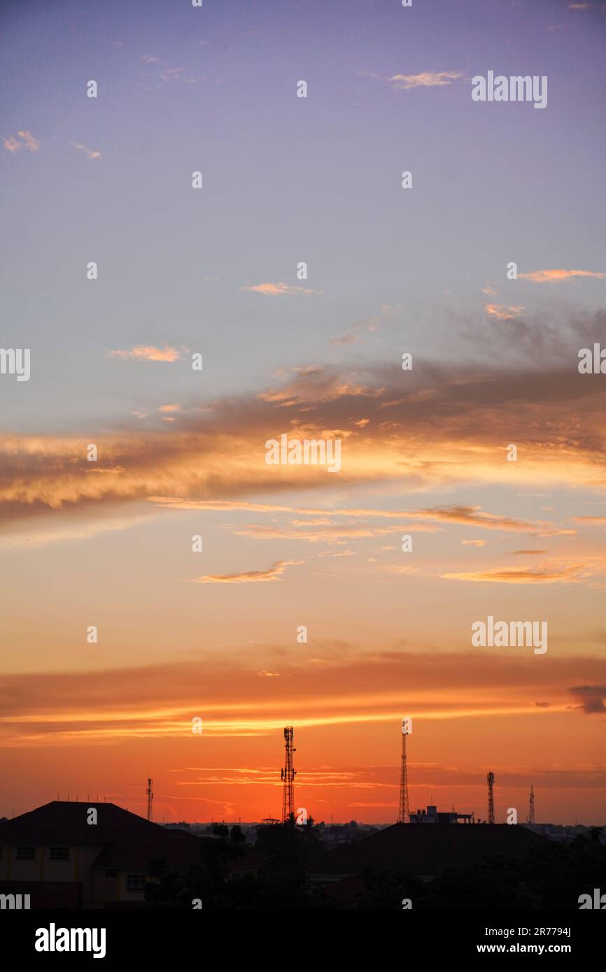 Sunset golden hour with silhouettes of buildings and towers Stock Photo ...
