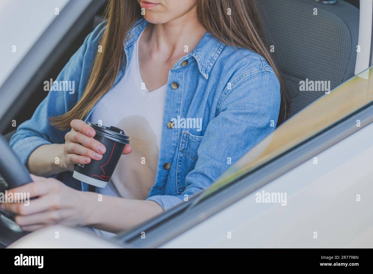 Unrecognizable Girl Spilling Coffee Or Tea On Herself While Driving A Car Spoiled Clothes