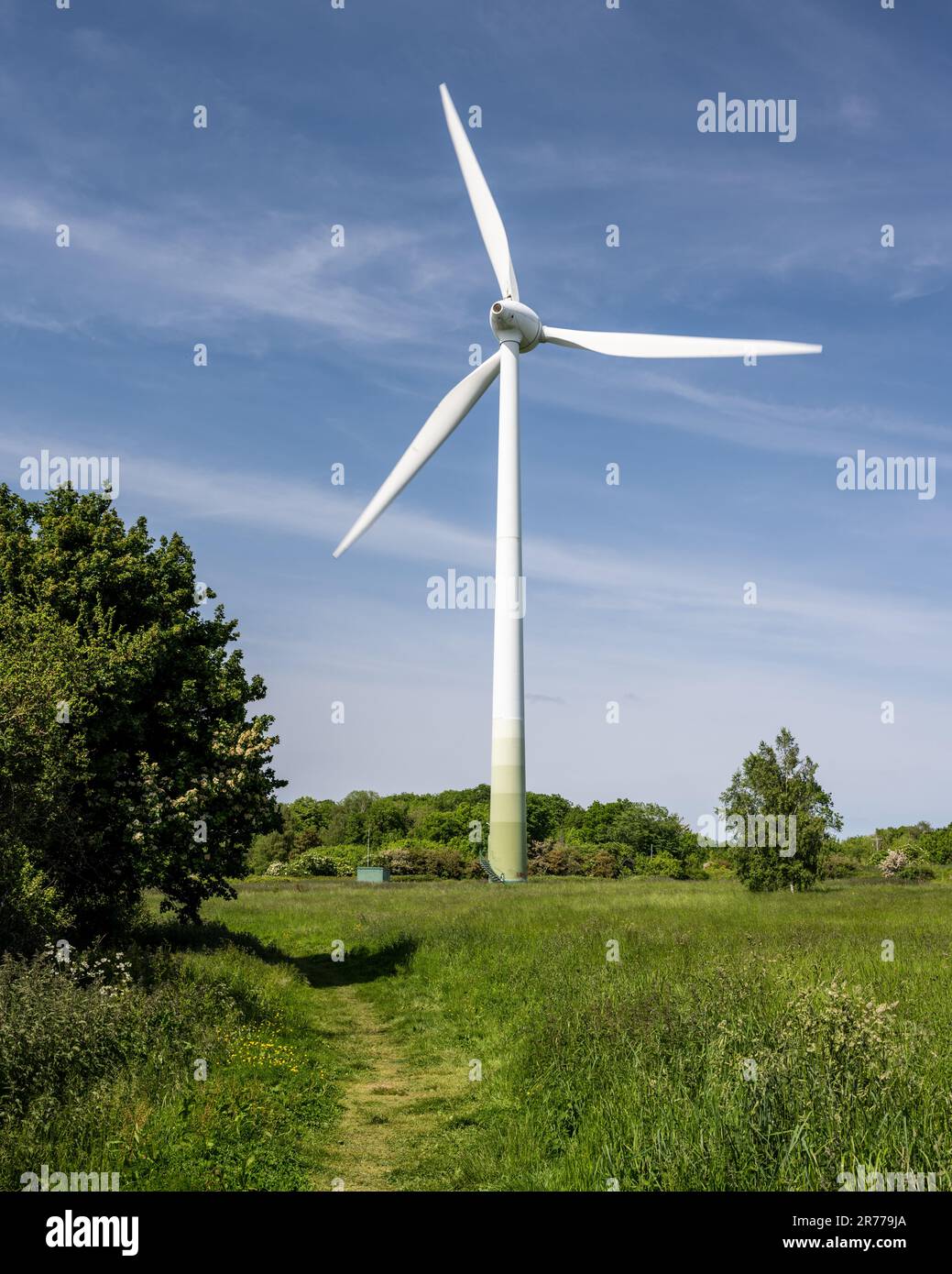 A wind turbine stands against a blue sky at Sharpness Docks in ...