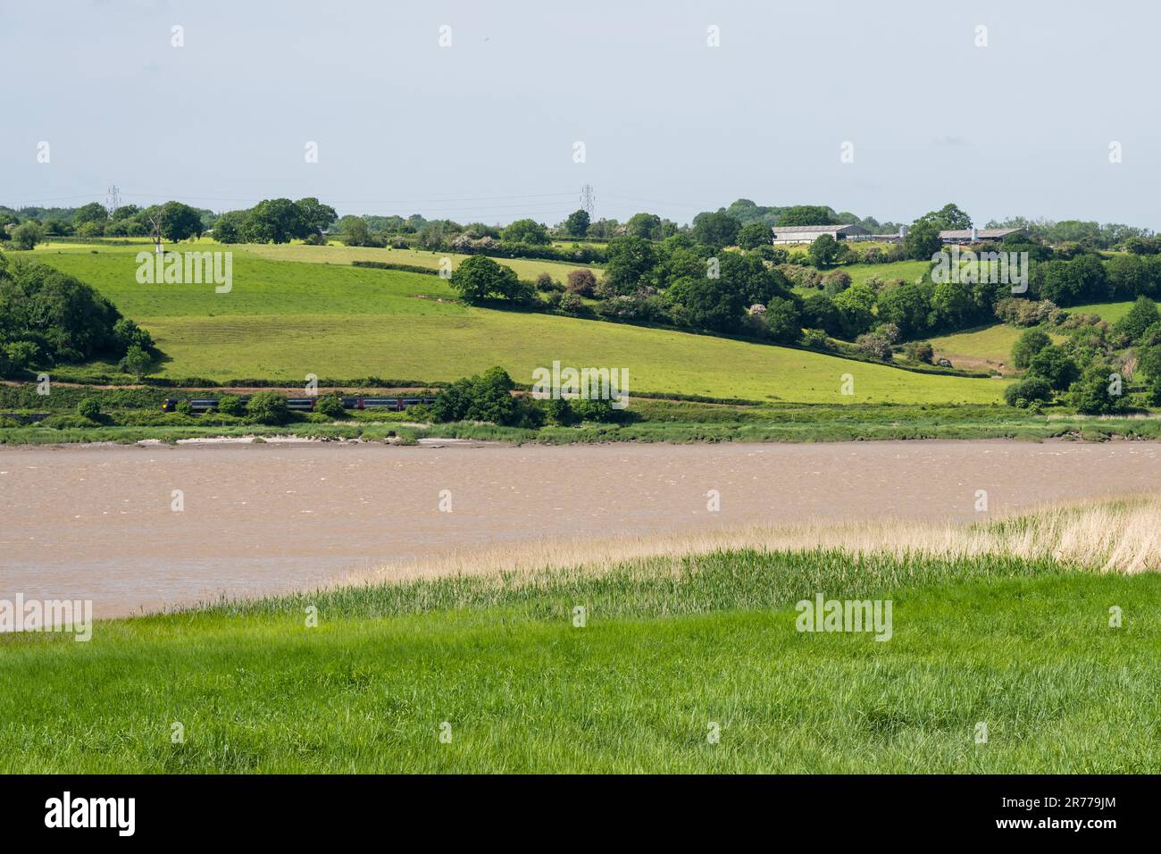 A CrossCountry passenger train travels alongside the Severn Estuary on ...