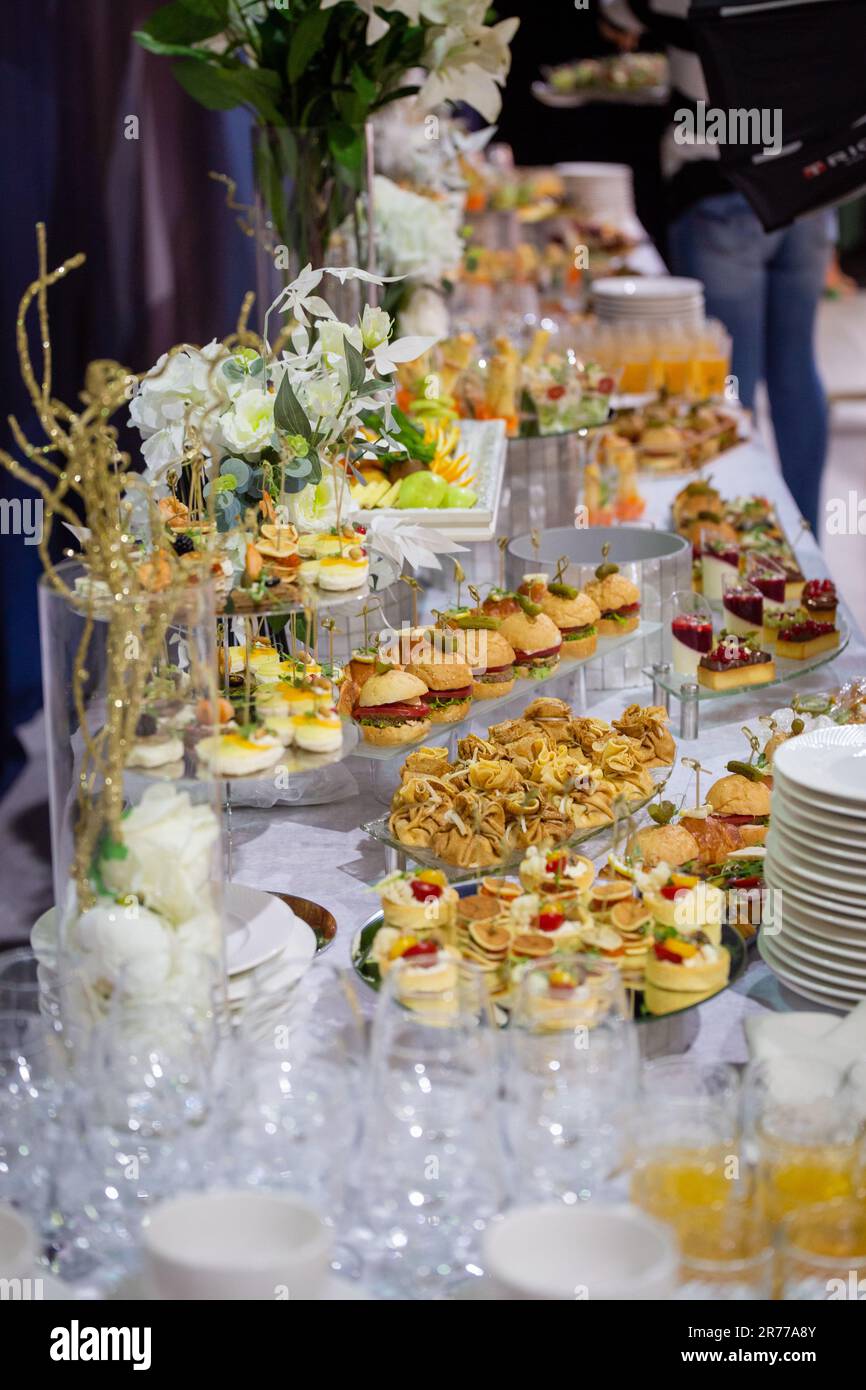 various snacks and drinks at the buffet table at the corporate catering ...