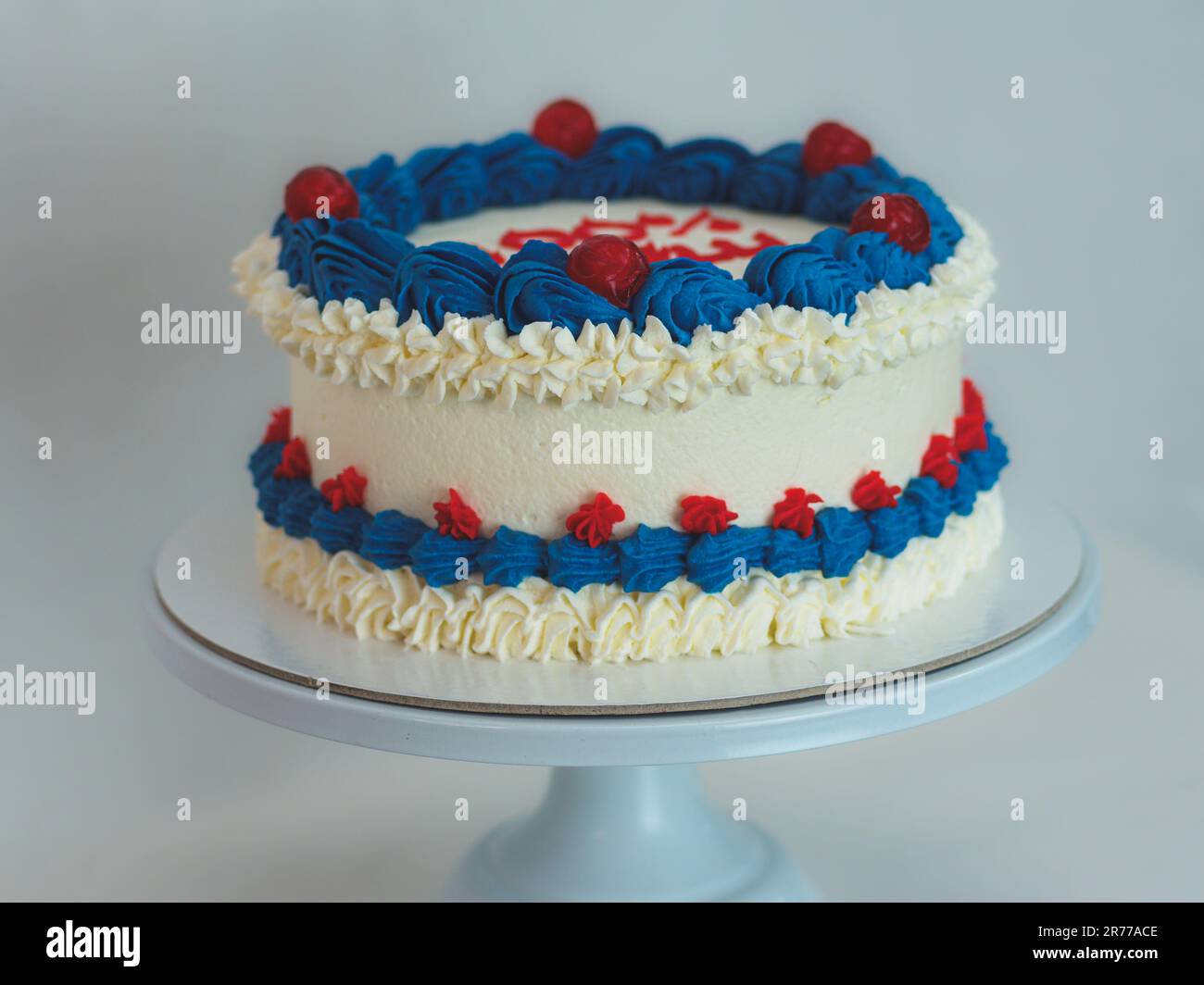 white blue red frosted icing cake isolated on studio white background ...