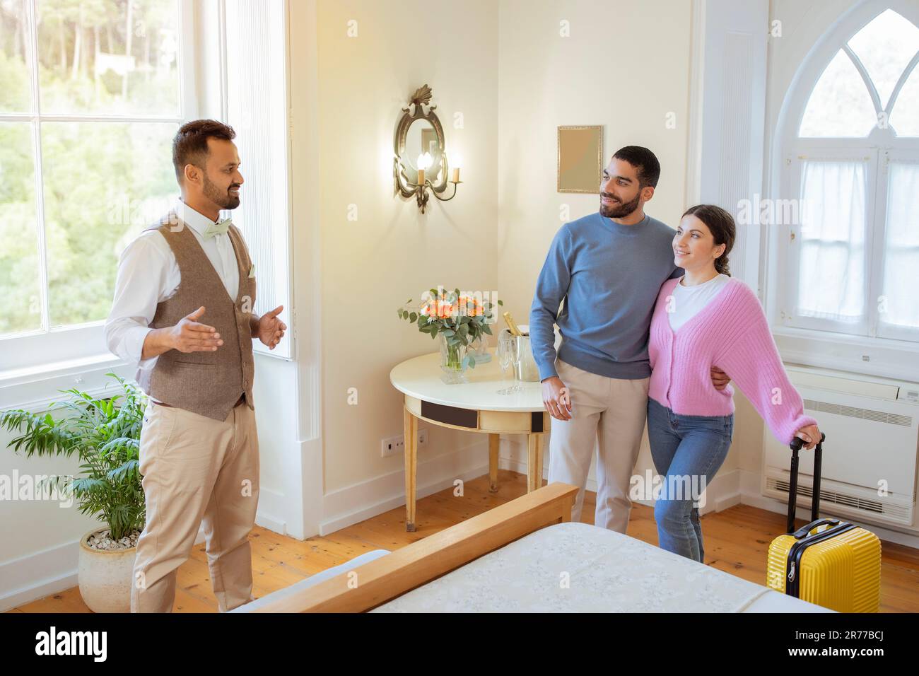 Staff Guy Showcasing Suite To Happy Couple Travelers At Hotel Stock ...