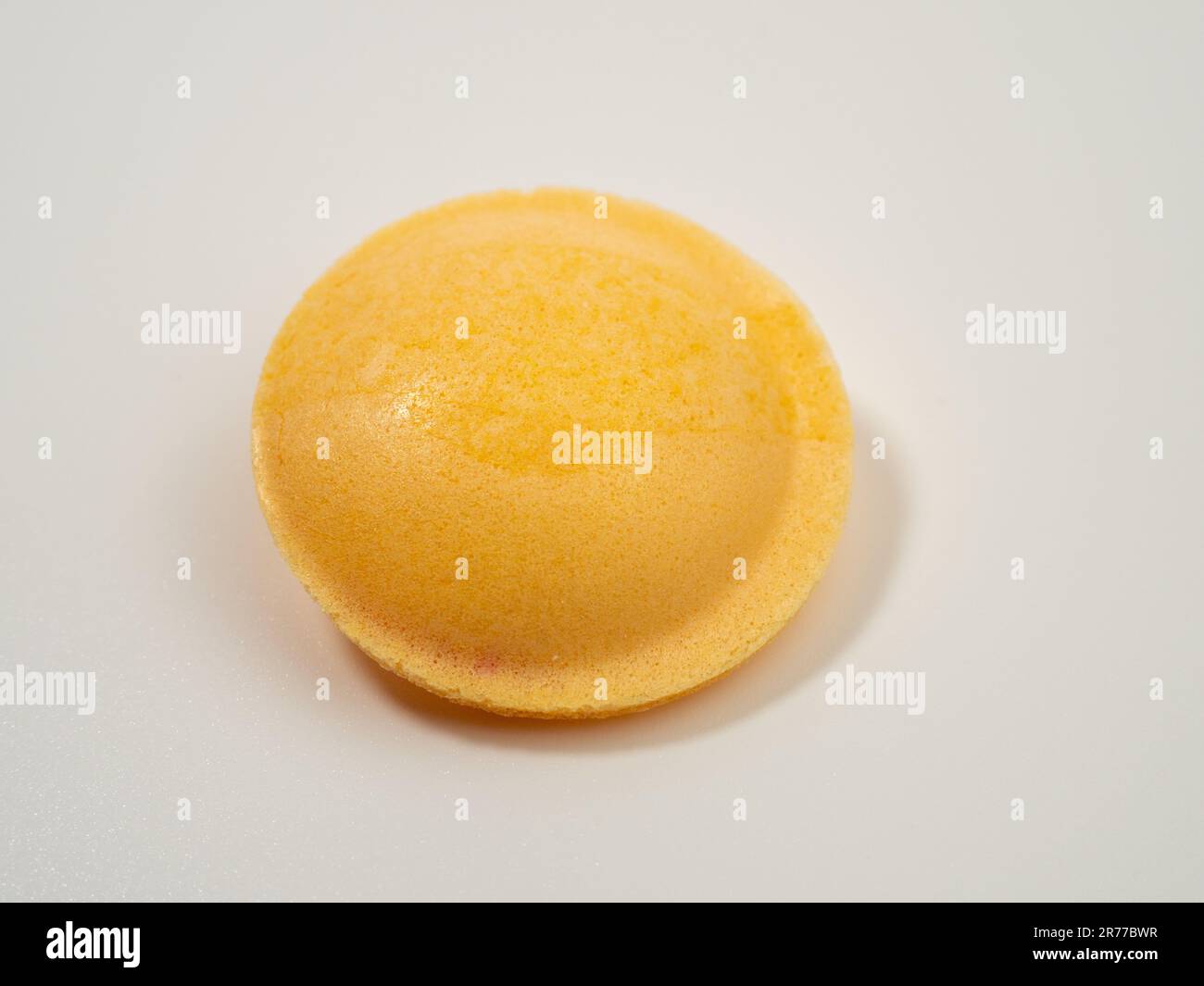 Sweet candies in the shape of a UFO in different colors on a white ...