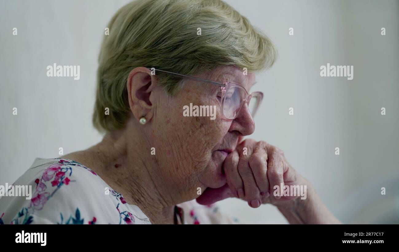Elderly Woman in Deep Contemplation at Home, Authentic Depiction of Old ...