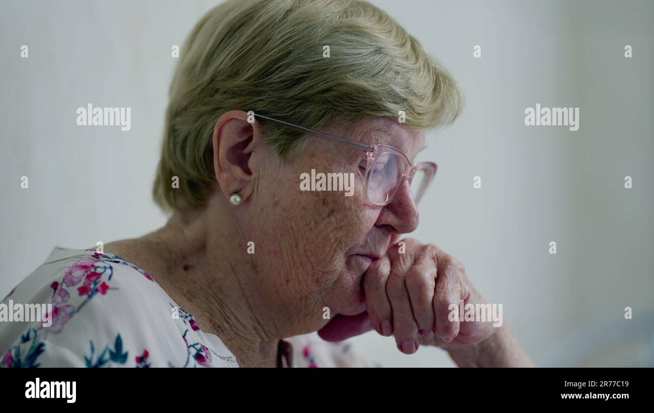 Elderly Woman in Deep Contemplation at Home, Authentic Depiction of Old ...