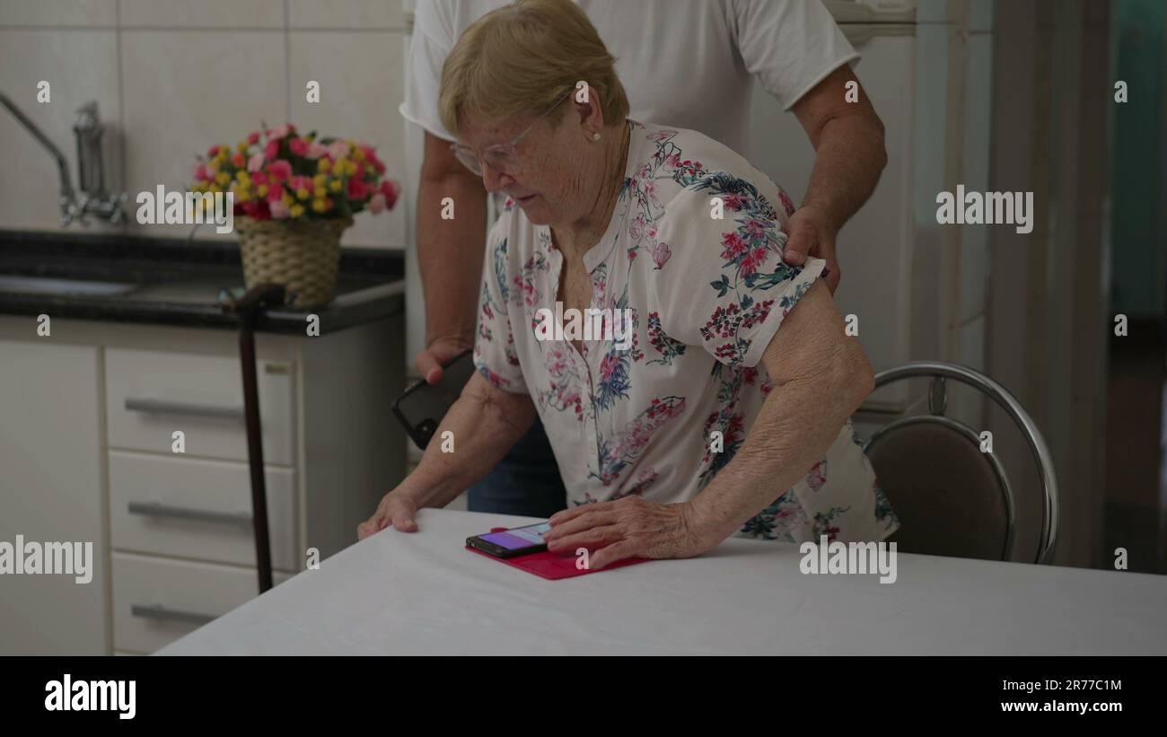 Elderly woman getting up from chair at home, authentic real life ...