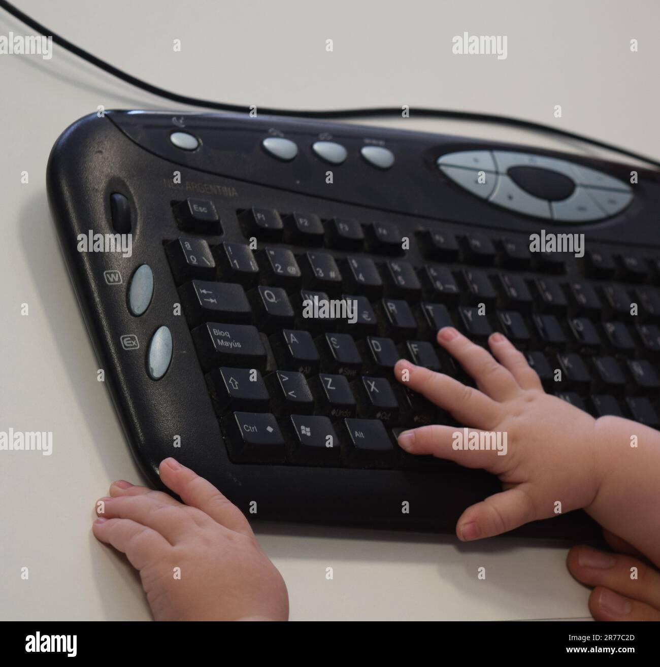Hand of a baby with the computer keyboard Stock Photo - Alamy
