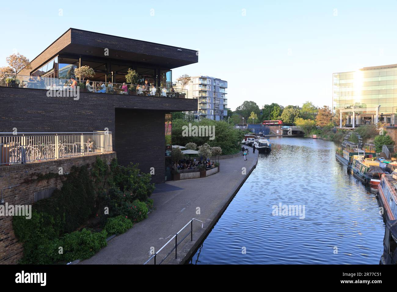 Spring sunshine on Regents Canal at Kings Cross, with diners sitting ...