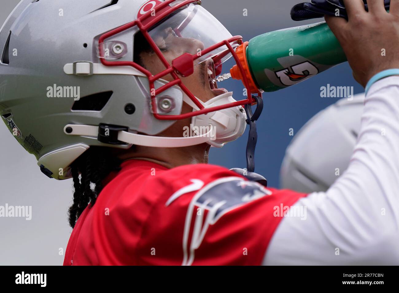 New England Patriots linebacker Marte Mapu takes a drink between field ...