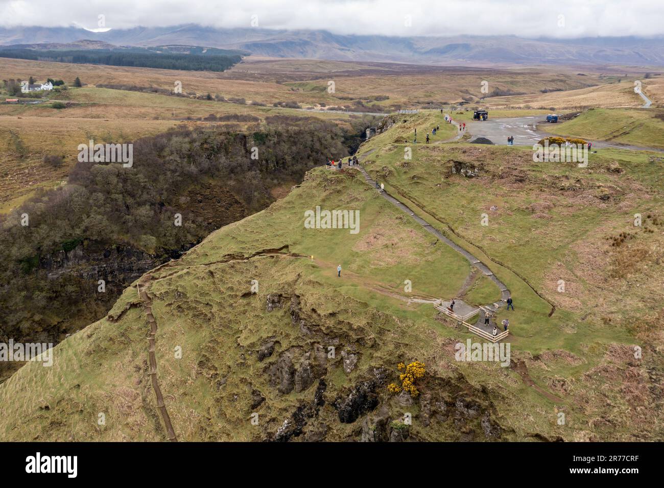 Aerial view of Lealt waterfall and basalt cliff near Staffin, tourists ...