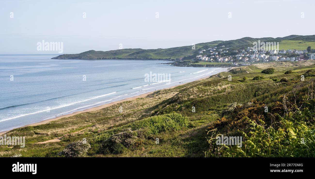 Sun shines on the beach and sand dune system at Woolacombe on the ...