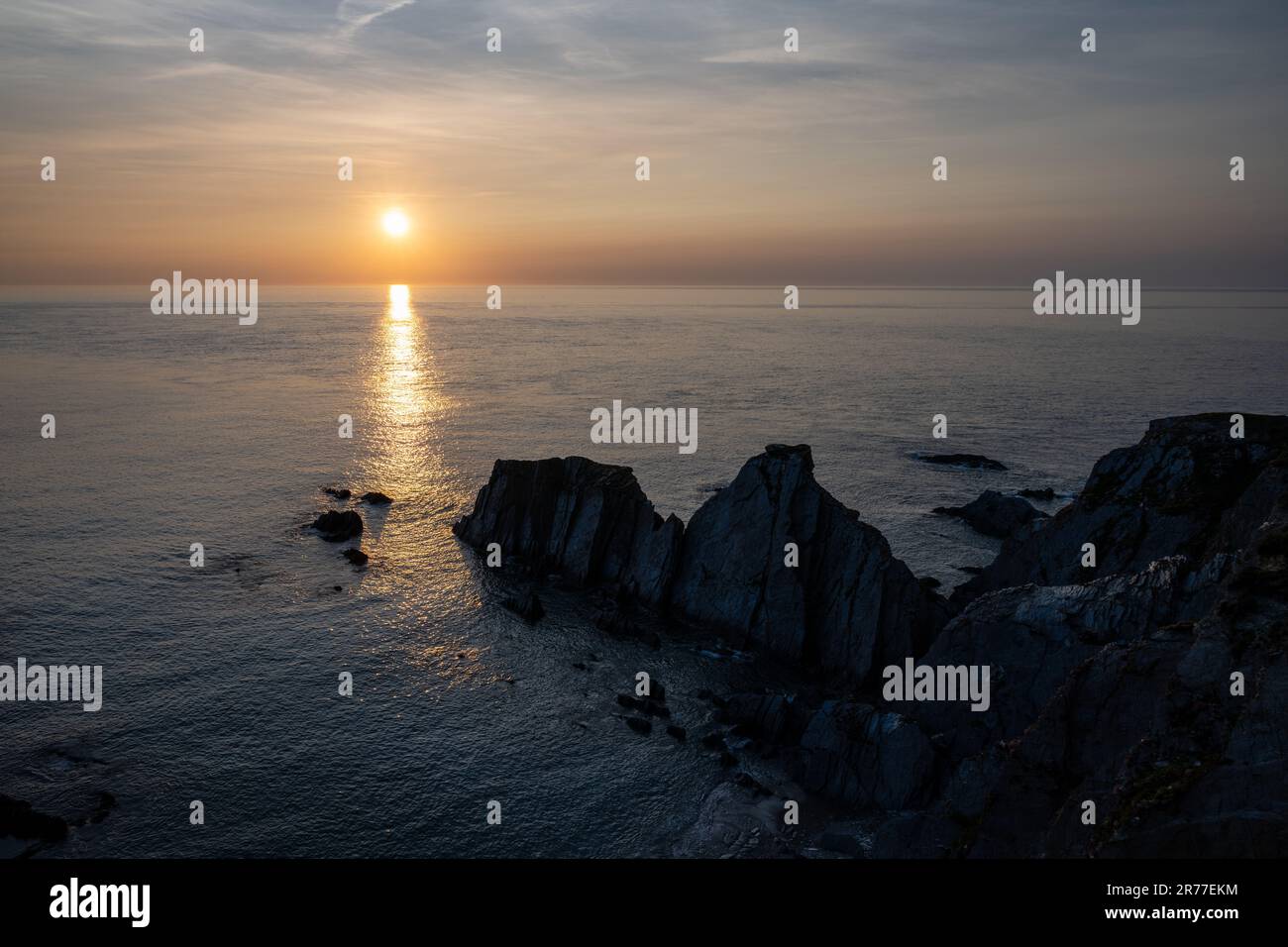 The sun sets over the Bristol Channel at Bull Point on the coast of ...