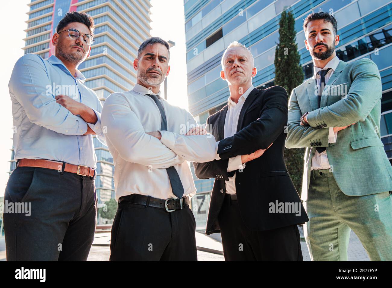 Four people standing arms hi-res stock photography and images - Alamy