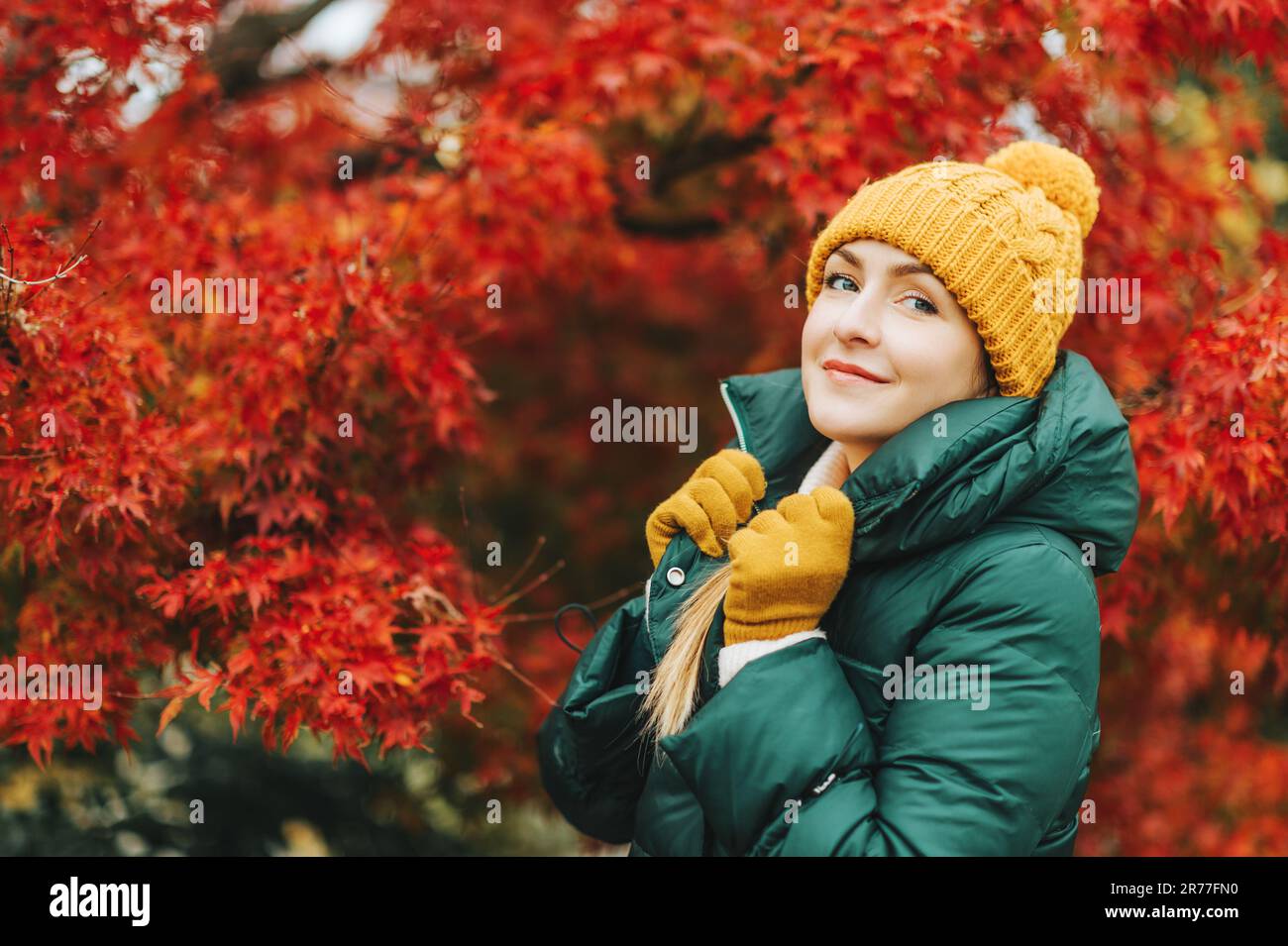 Autumn portrait of young beautiful woman wearing green jacket and set ...