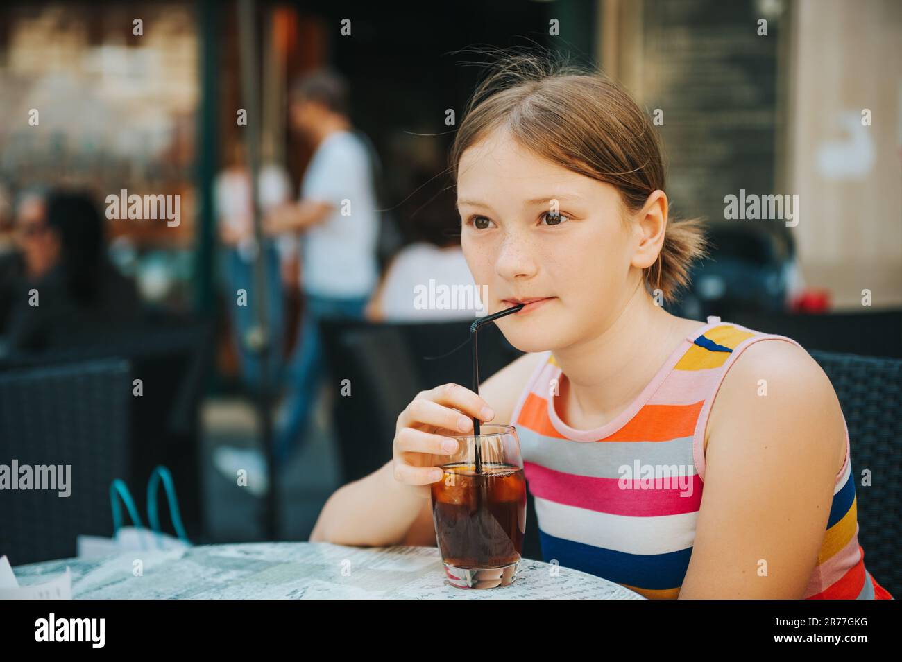 Little girl drinking ice tea in outside cafe Stock Photo - Alamy
