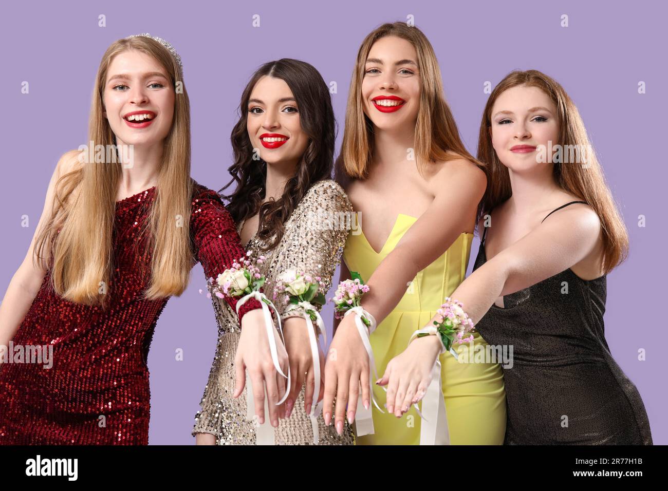 Young women dressed for prom with corsages on lilac background Stock ...