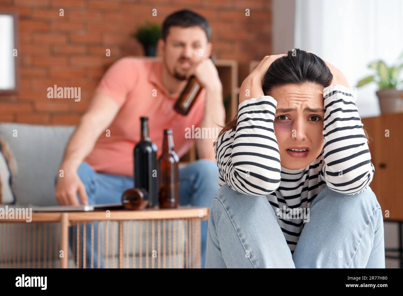 Scared young woman and her drunk husband at home, closeup. Domestic ...