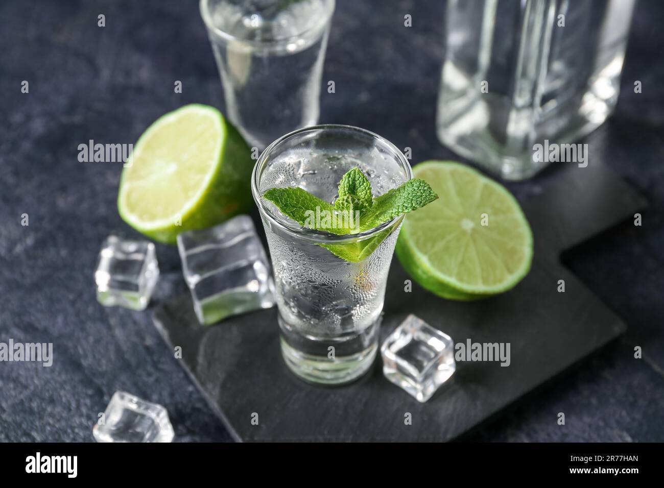 Glass of cold vodka on black background Stock Photo - Alamy