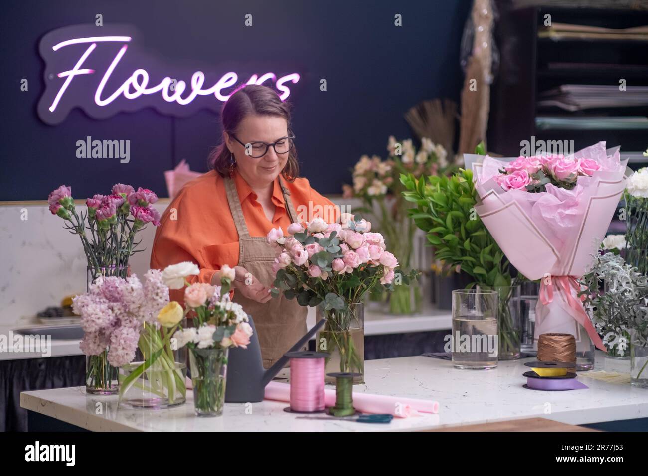 successful female entrepreneur owner of flower shop stands with ...