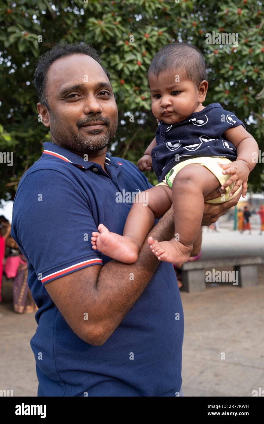 A father hugs his baby daughter while strolling historic French Quarter ...