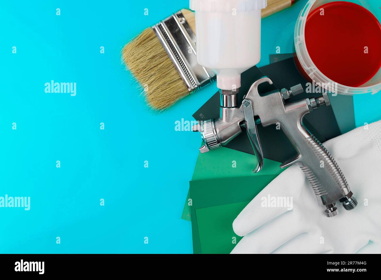 Paint spray gun at work at the workplace in the workshop. Paint Brush ...