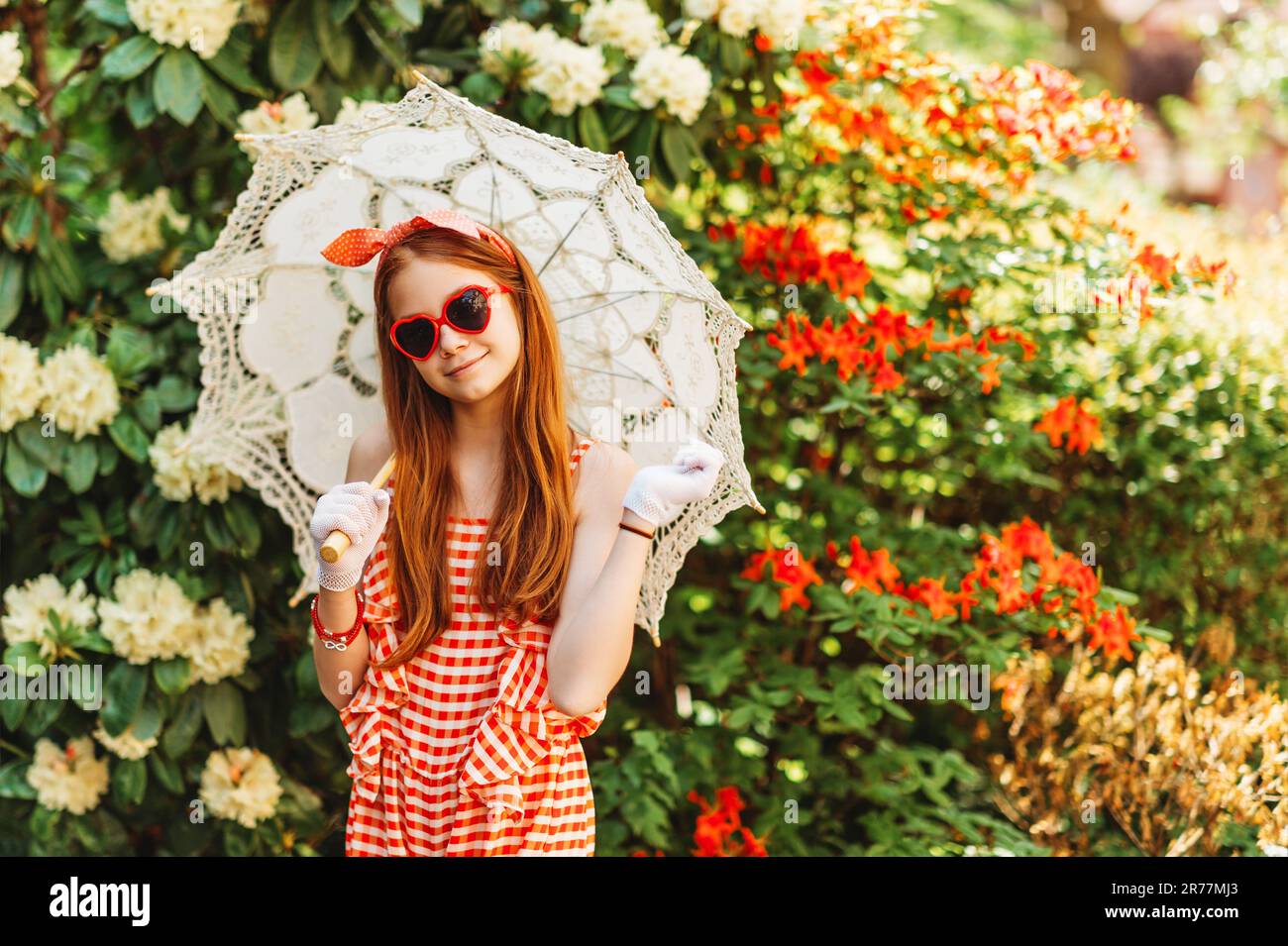 Funny little girl wearing gingham playsuit, heart shaped sunglasses ...