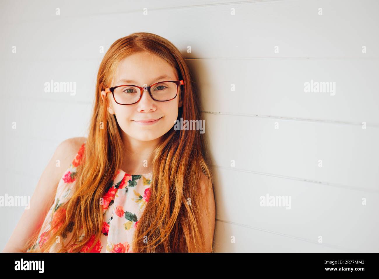 Portrait of adorable preteen kid girl of 10-11 yers old with long red ...