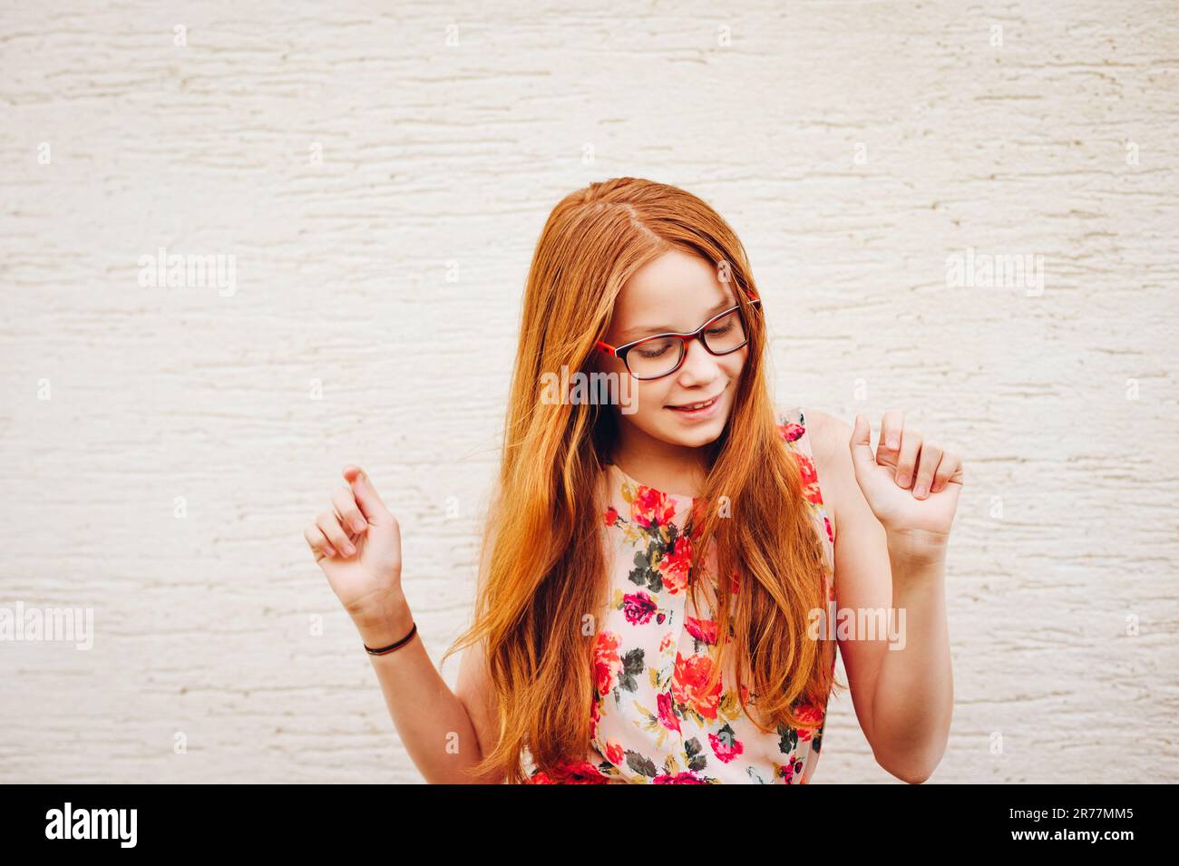 Portrait of adorable preteen kid girl of 10-11 yers old with long red ...