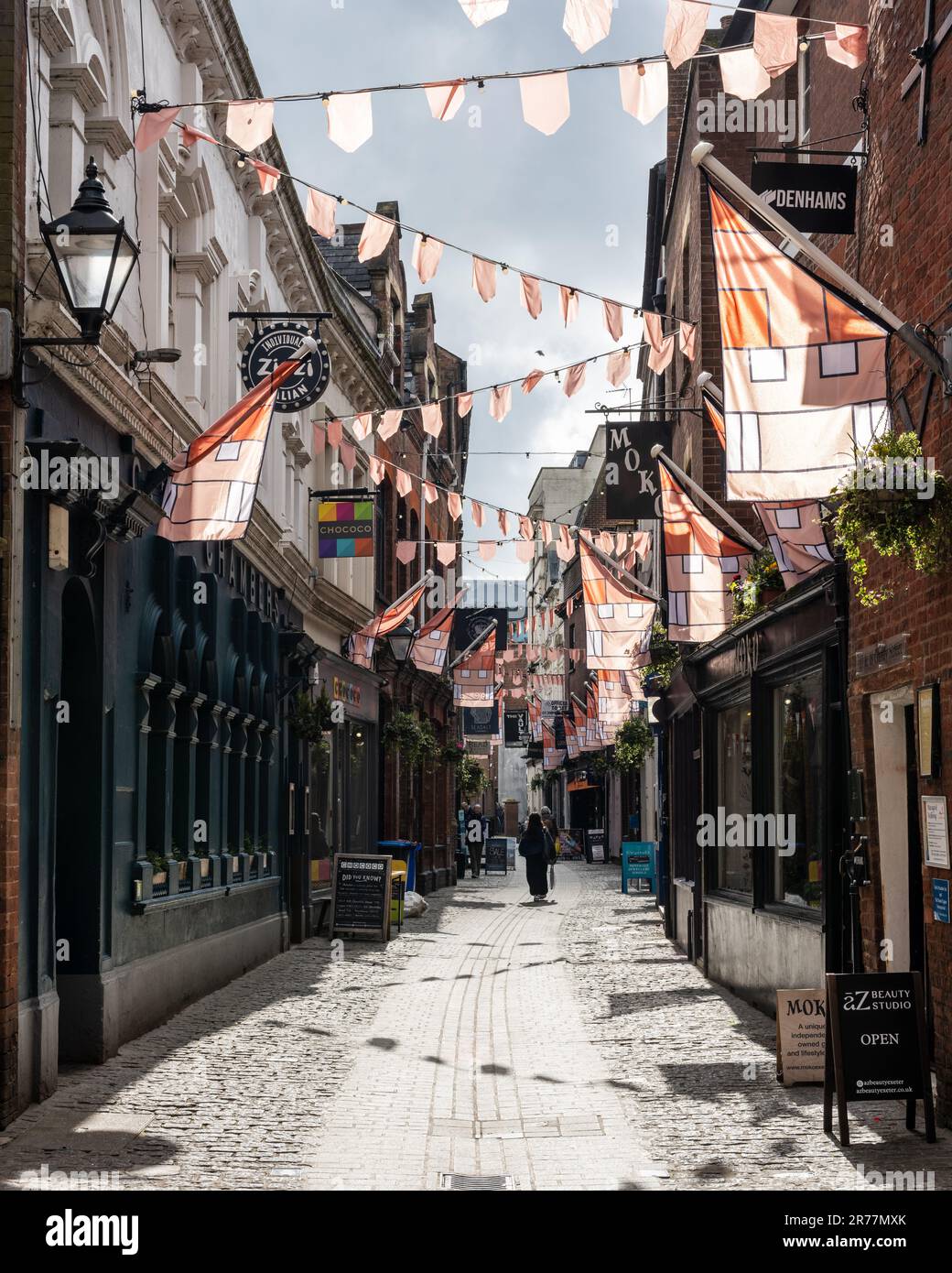 Pedestrians walk past shops on the narrow cobbled Gandy Street in ...