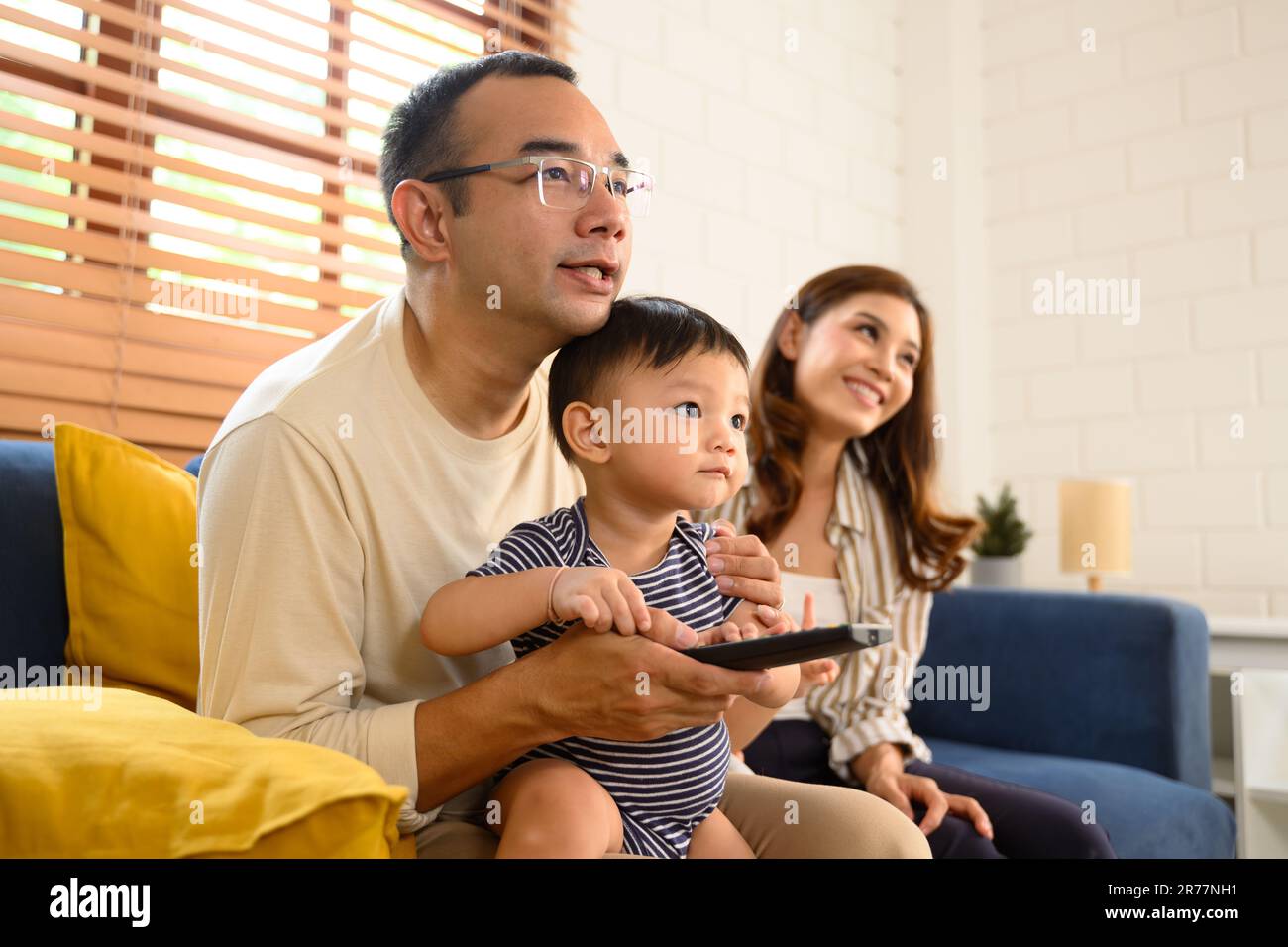 family playing fun together at living room. Family watching TV Show ...