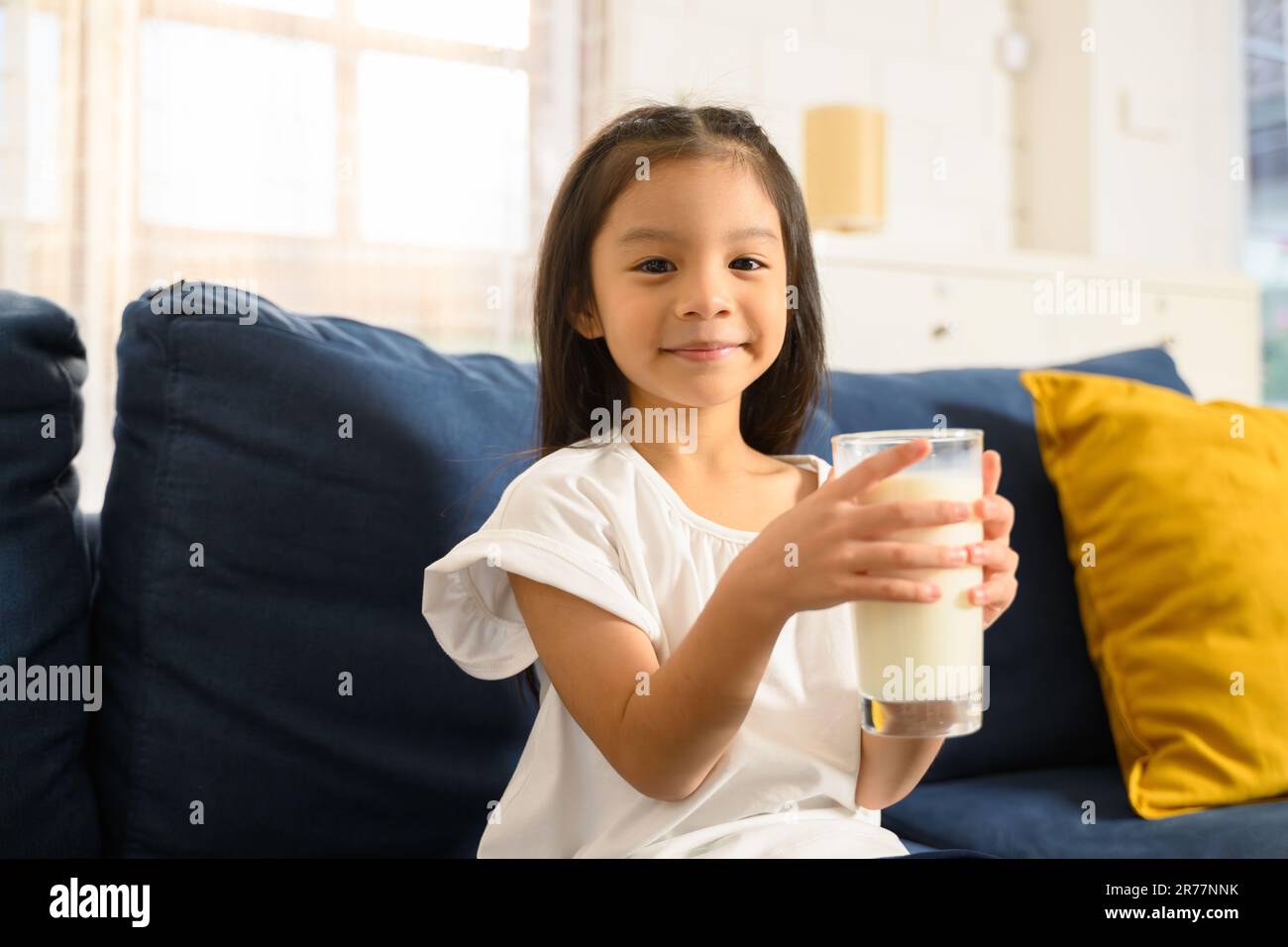 child drink milk. Girl drinking milk at living room Stock Photo - Alamy