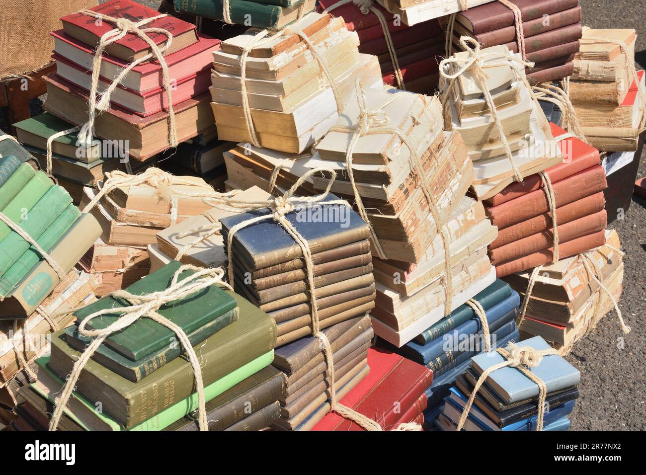 Bundles of old books tied up with string Stock Photo - Alamy
