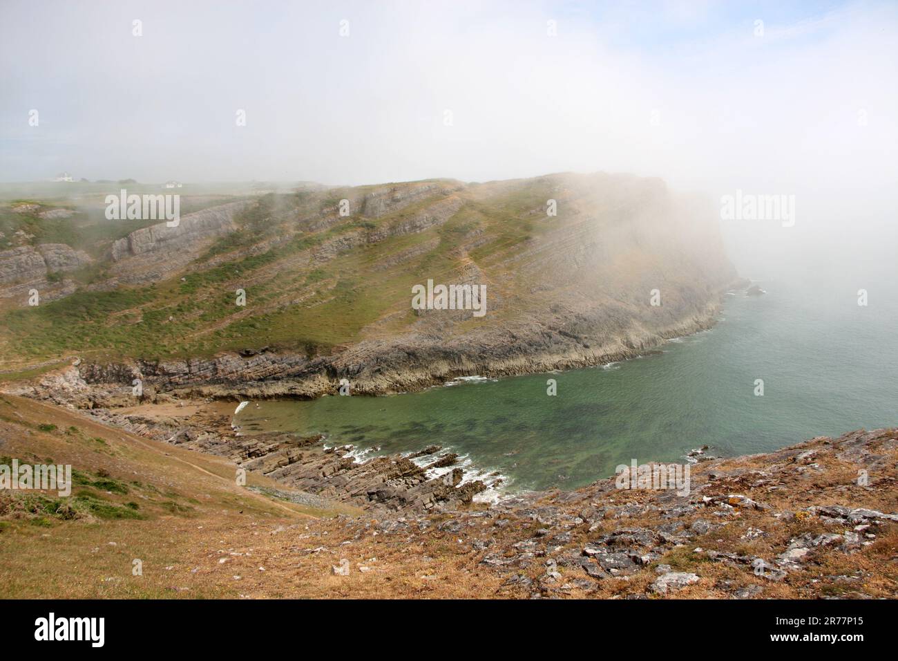 Mist gathering over a cove at Rhosilli Bay Gower Peninsula Wales Stock ...