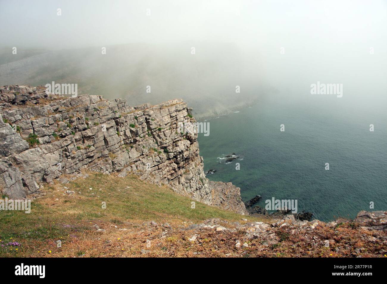 Mist gathering over a cove at Rhosilli Bay Gower Peninsula Wales Stock ...