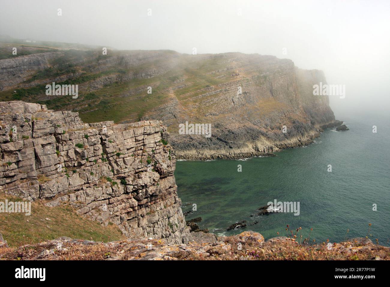 Mist gathering over a cove at Rhosilli Bay Gower Peninsula Wales Stock ...