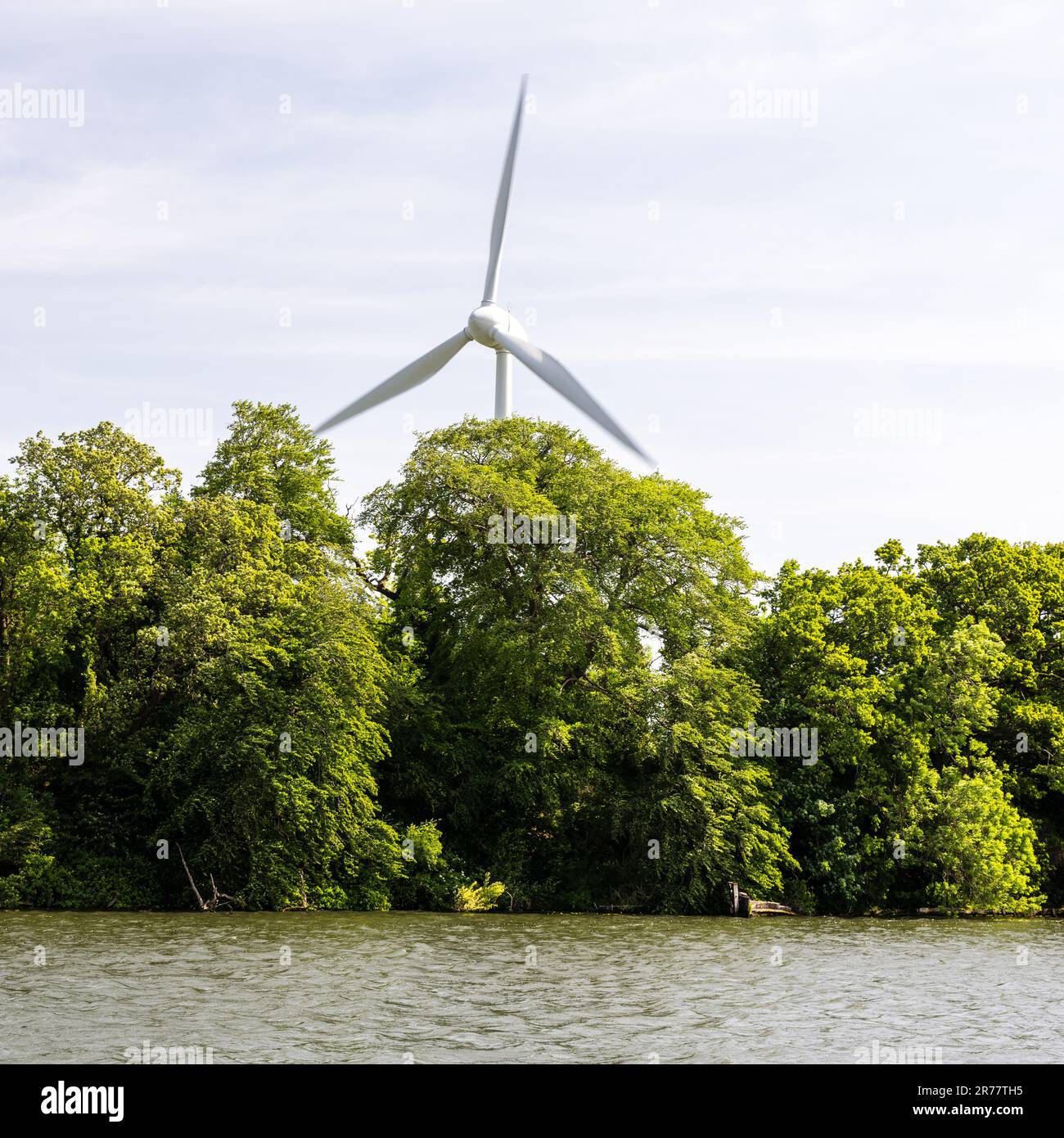 A wind turbine stands over the Gloucester and Sharpness Canal at ...
